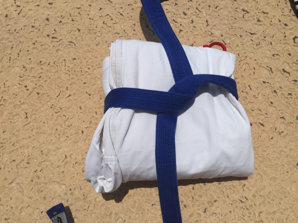 How to Fold Your Jiu Jitsu Gi for Travel - BJJ Mat Rat